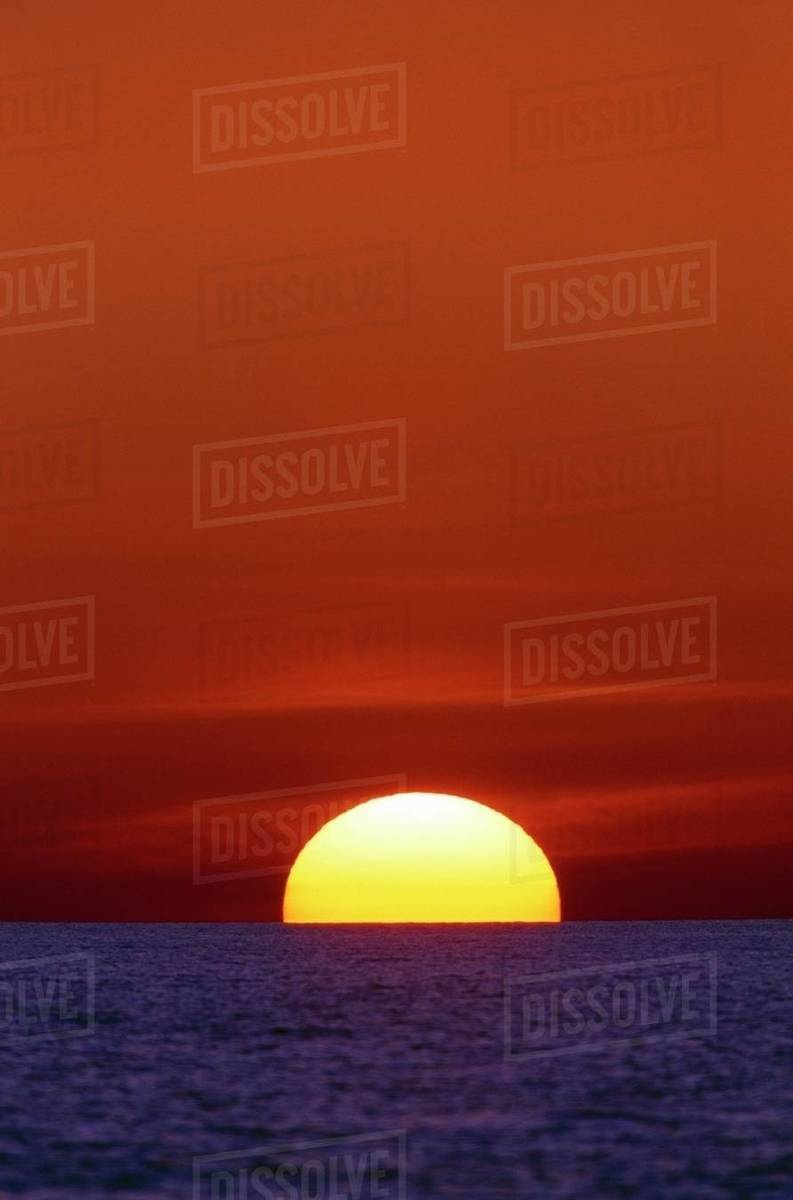 Sun Setting Over The Ocean - Royalty-free Stock Photo | Dissolve