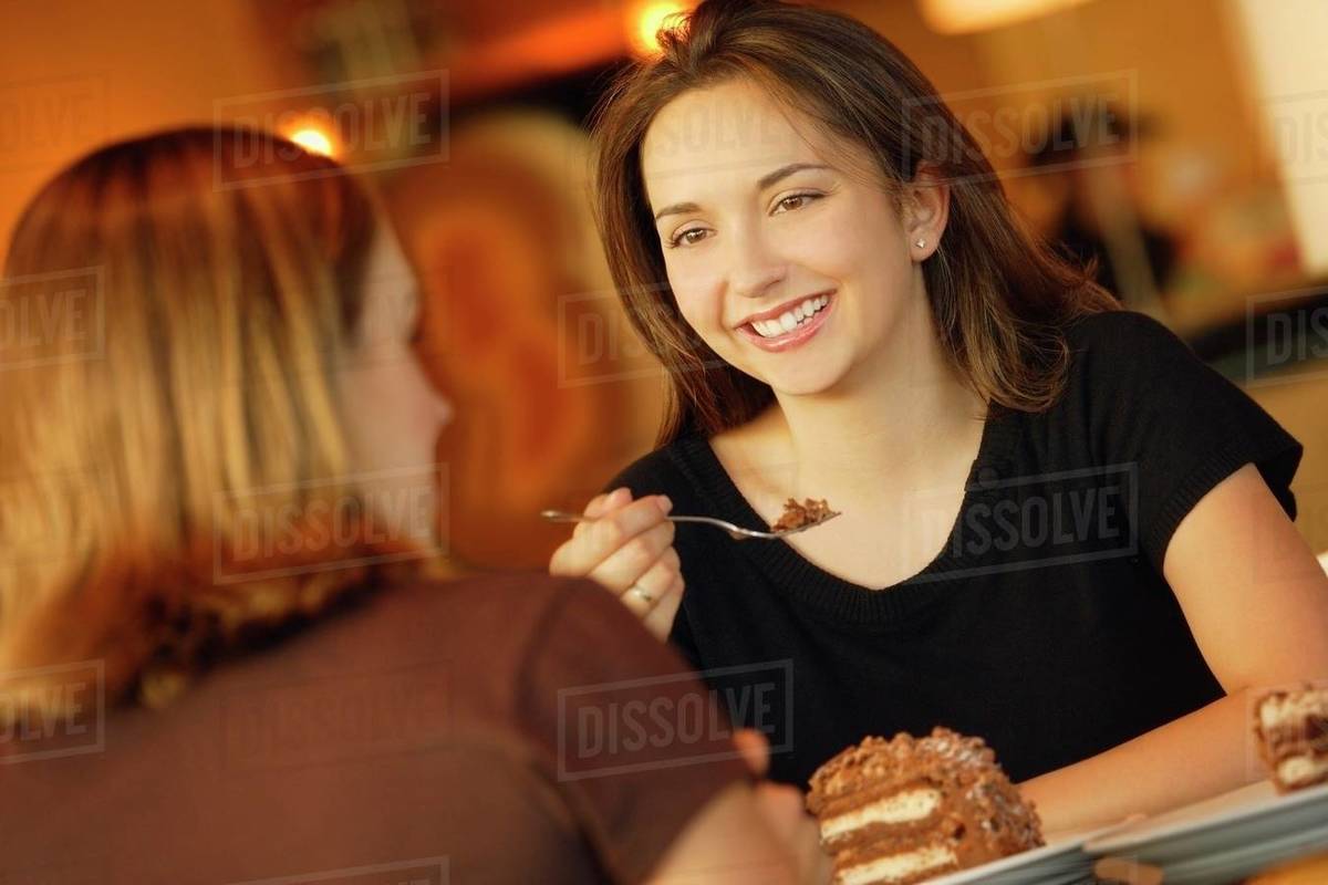 Two Friends Enjoying Dessert - Royalty-free Stock Photo | Dissolve