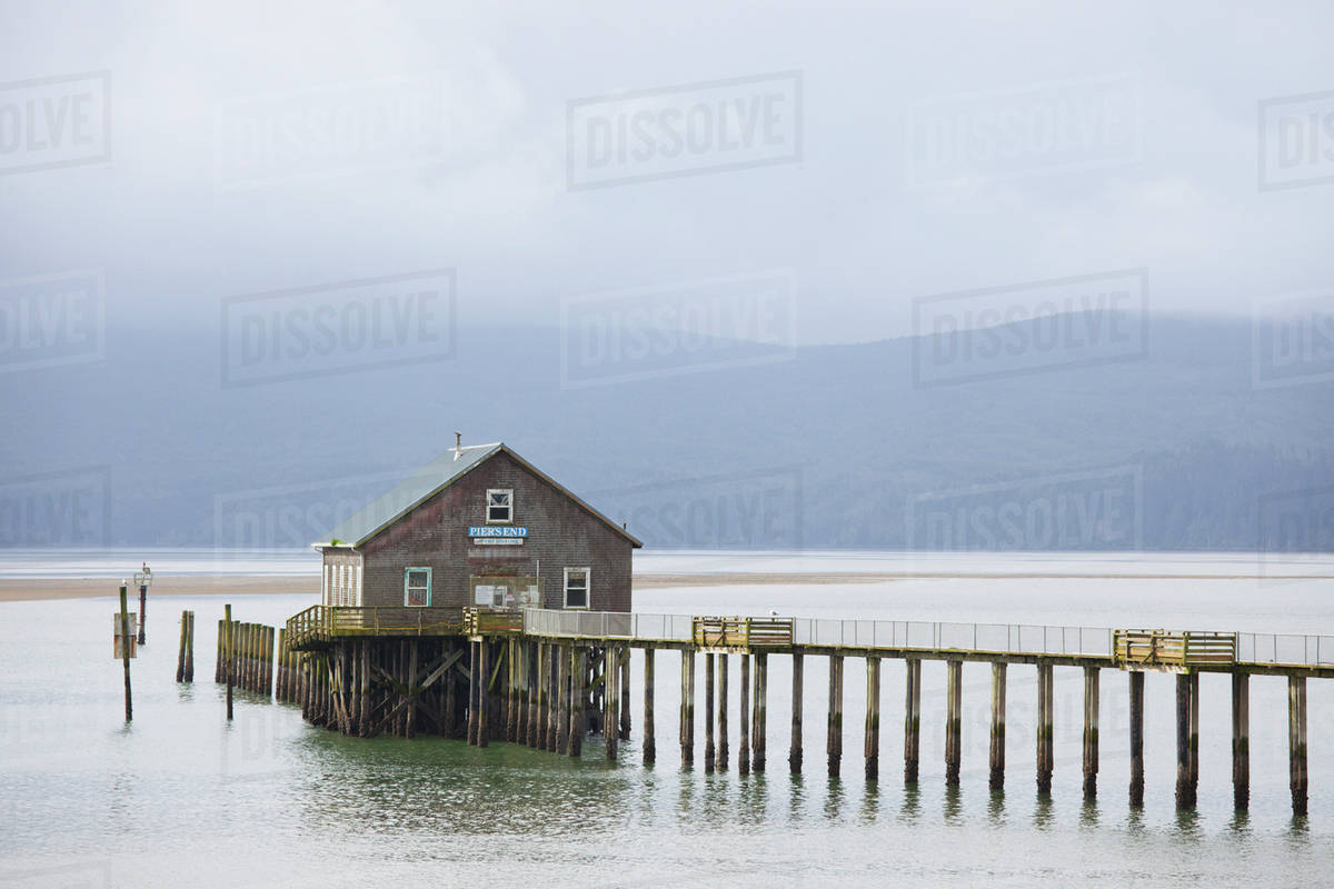 Dock in the water with a shack; Oregon, United States of America ...