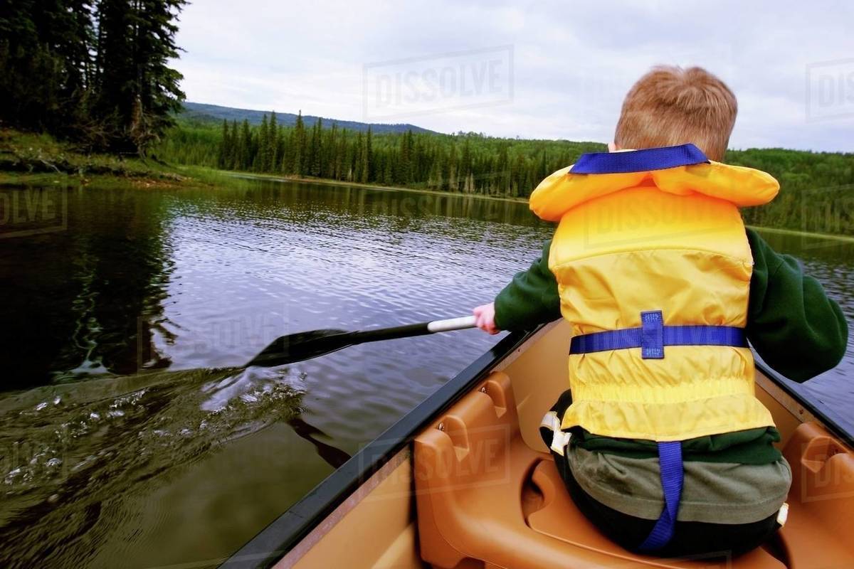 Child Rows A Canoe - Royalty-free Stock Photo | Dissolve