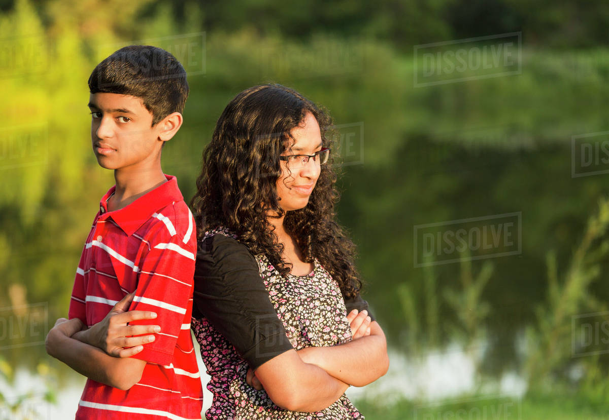 Brother and sister having a disagreement and ignoring each other ...