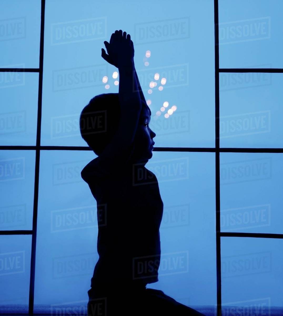 Silhouette Of Small Boy In Window - Stock Photo - Dissolve
