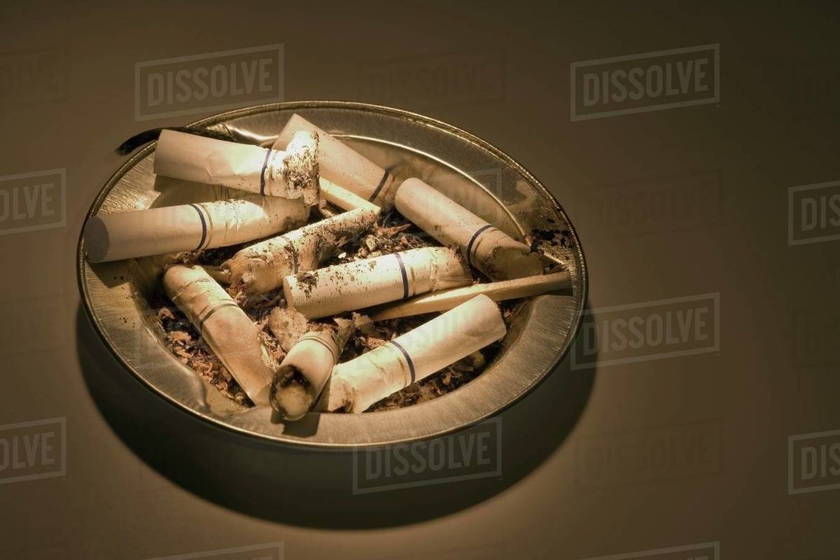 Full Ashtray Receptacle - Stock Photo - Dissolve