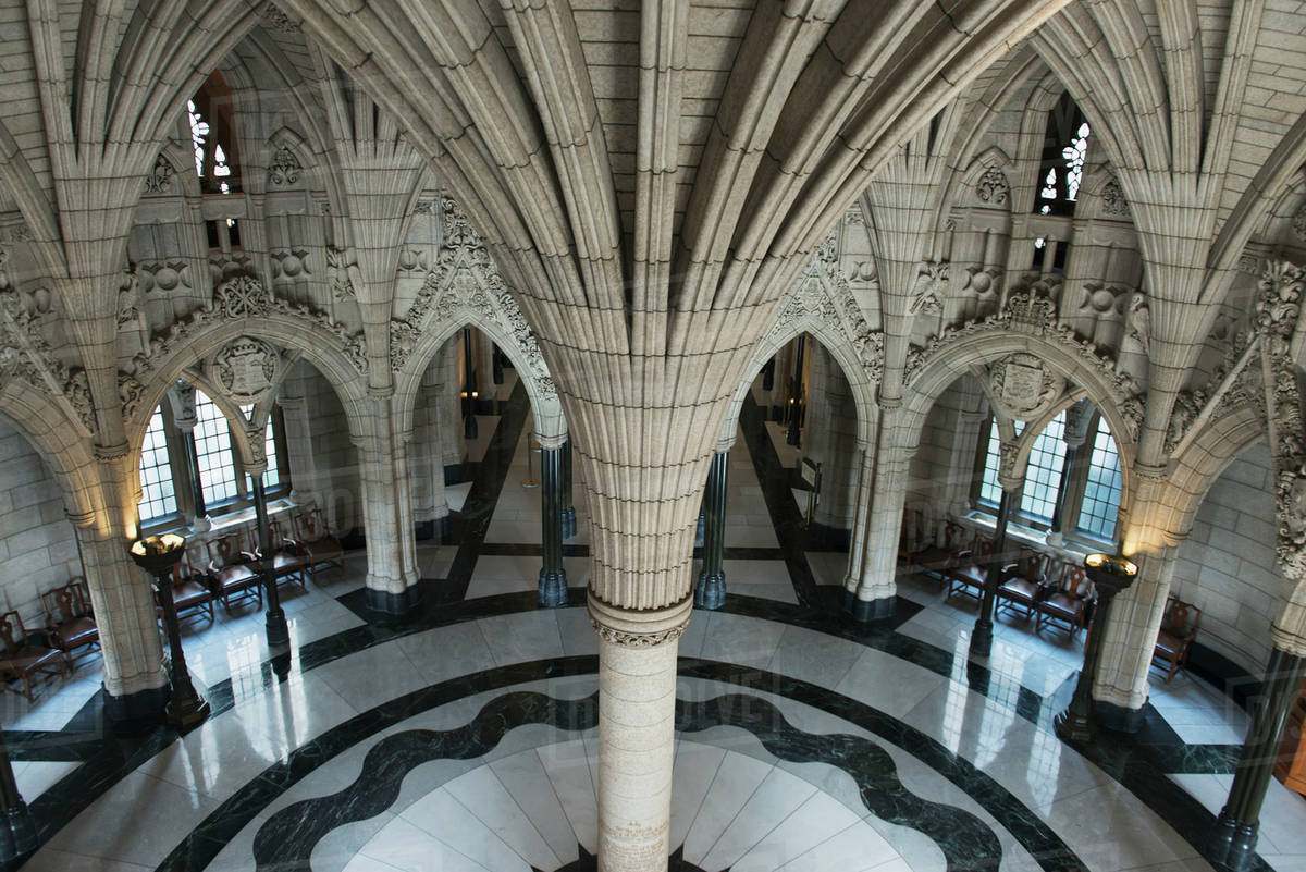 Ornate interior of a building with pillars and black and white flooring ...