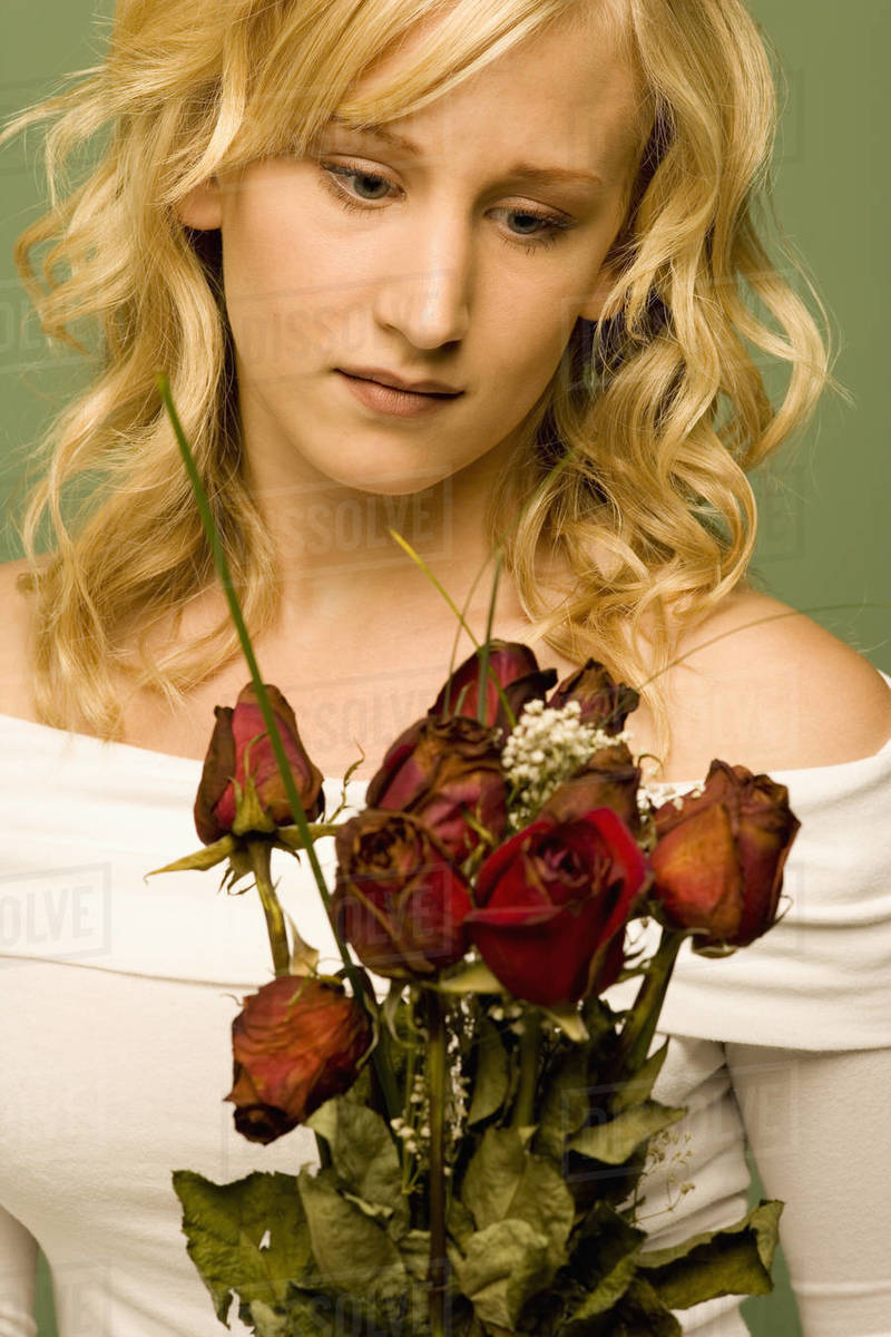 Young Woman With Withered Roses - Stock Photo - Dissolve