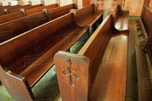 Wooden pews in a church with crosses etched into the ends;New orleans ...