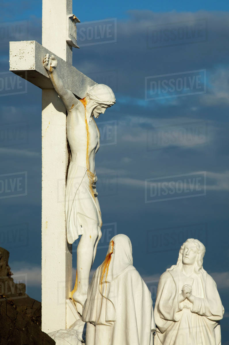 Statue of jesus christ on the cross with two women at the foot of the ...
