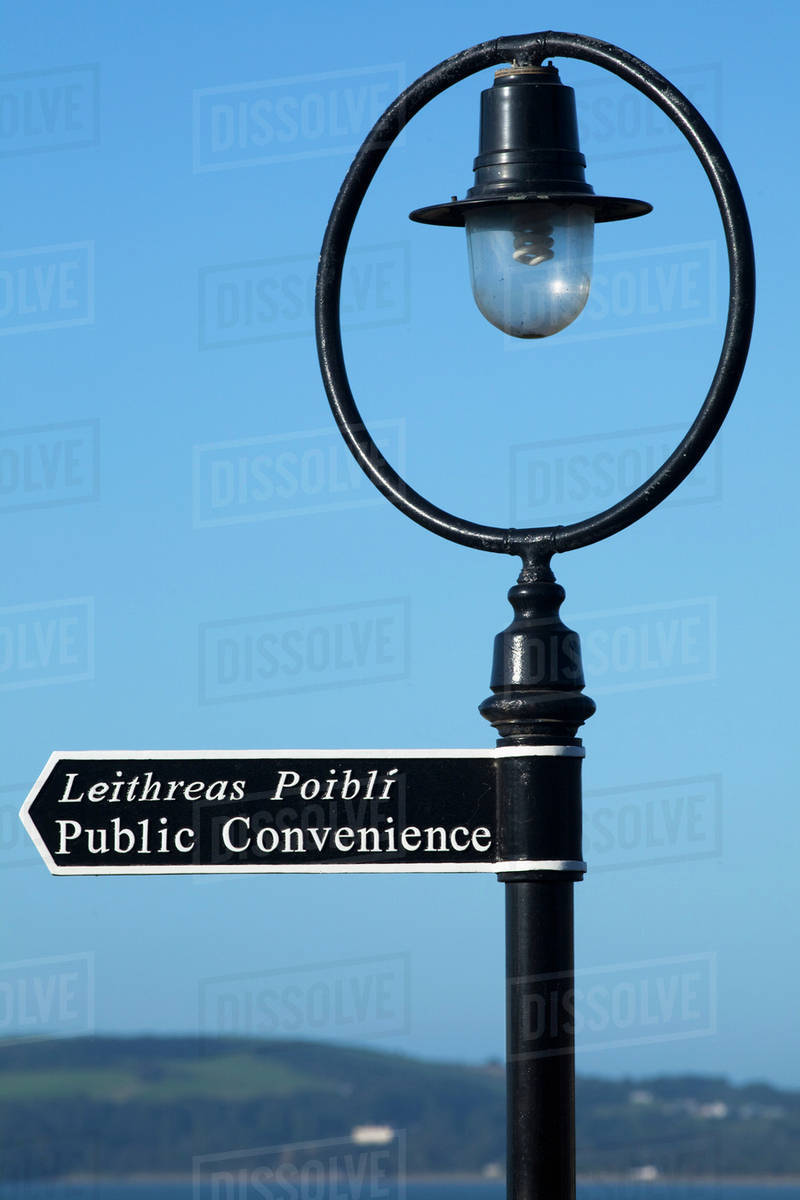 Signpost with light against a blue sky;Duncannon, county wexford ...