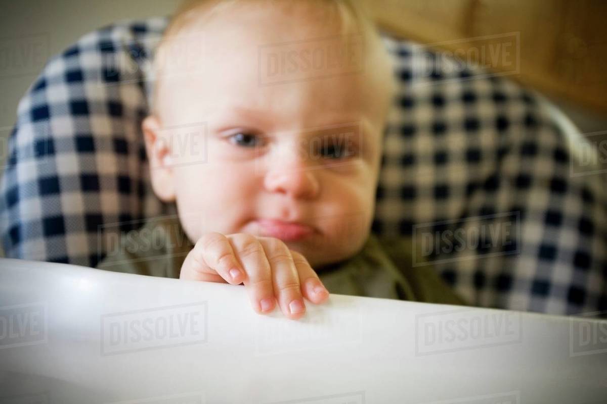 Baby Boy Pouting In Highchair - Royalty-free Stock Photo | Dissolve