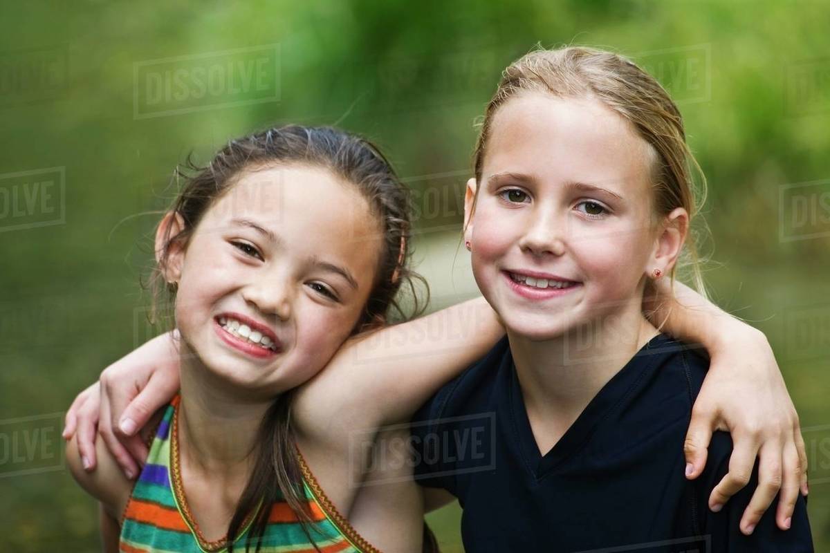Portrait Of Two Girls Hugging - Royalty-free Stock Photo | Dissolve