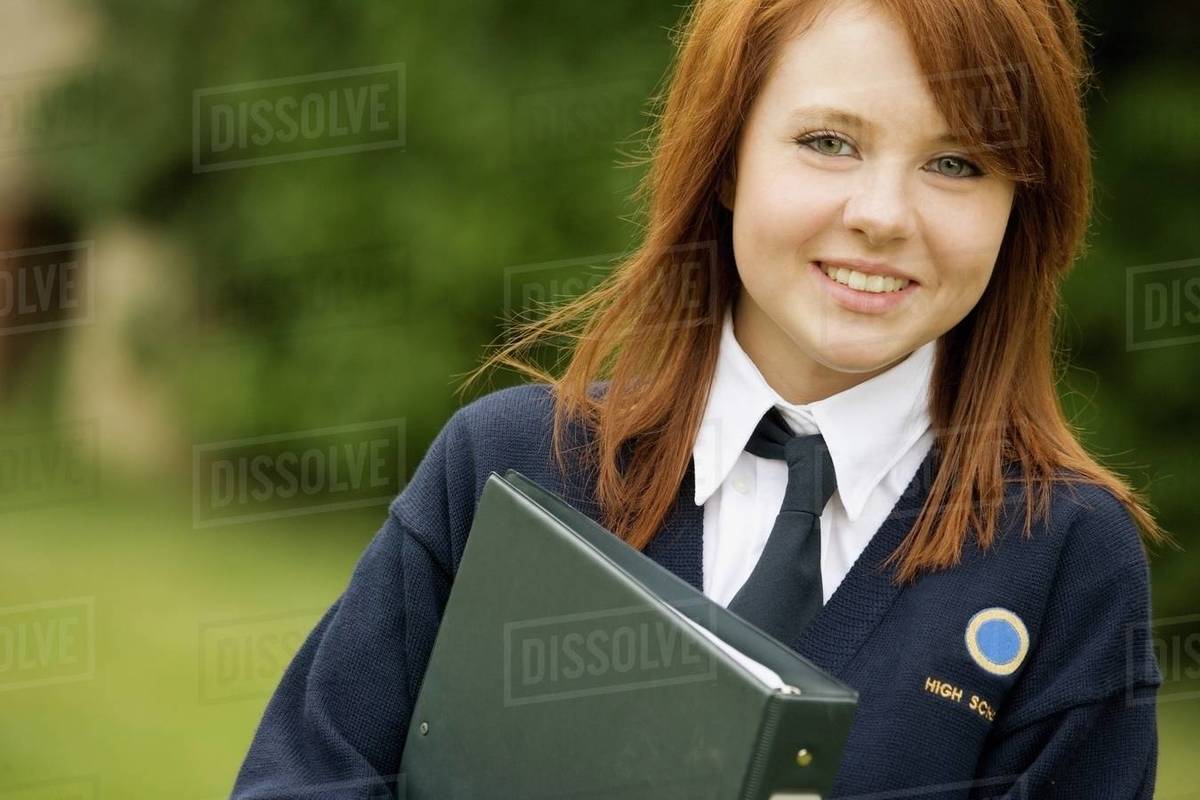 Young Girl With Binder - Stock Photo - Dissolve