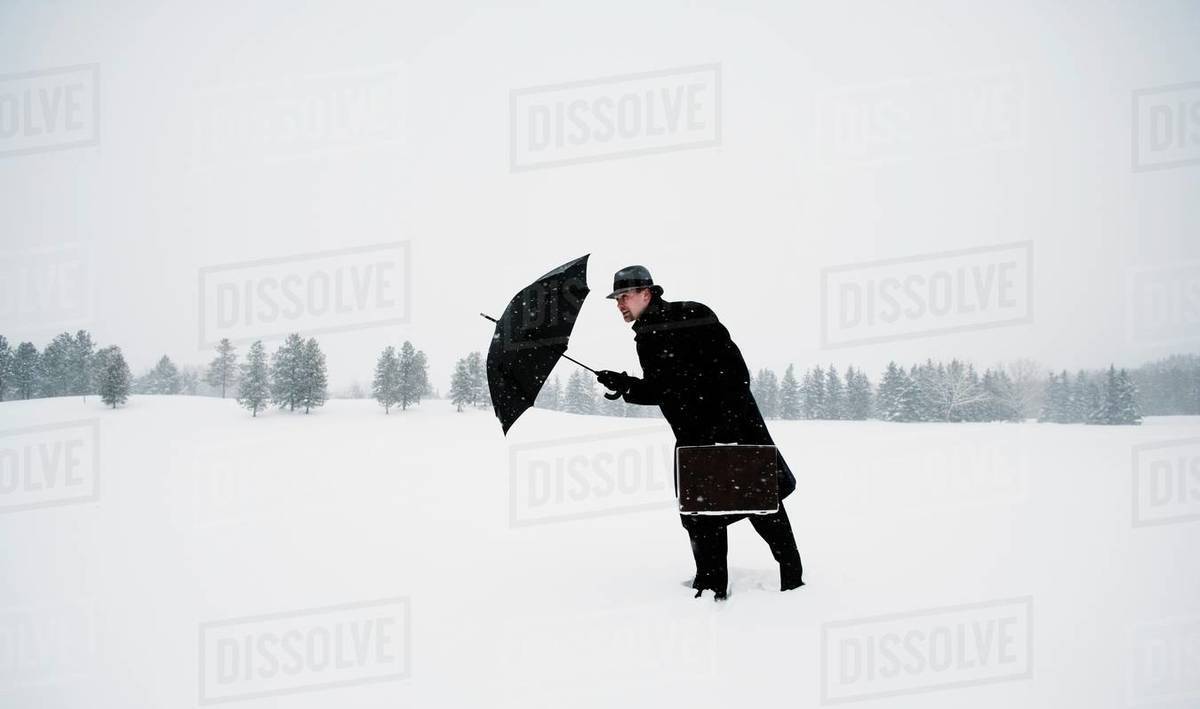 Man Battling Against The Snow - Stock Photo - Dissolve