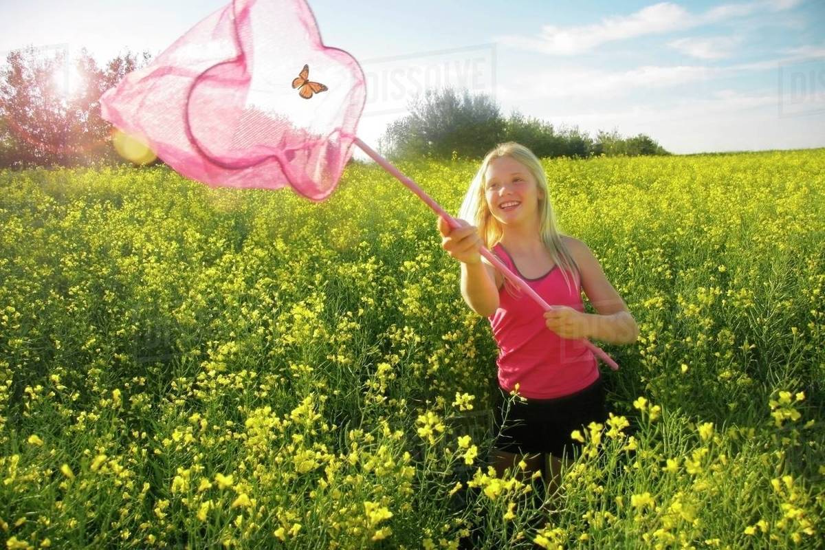 Woman Catching A Butterfly - Stock Photo - Dissolve