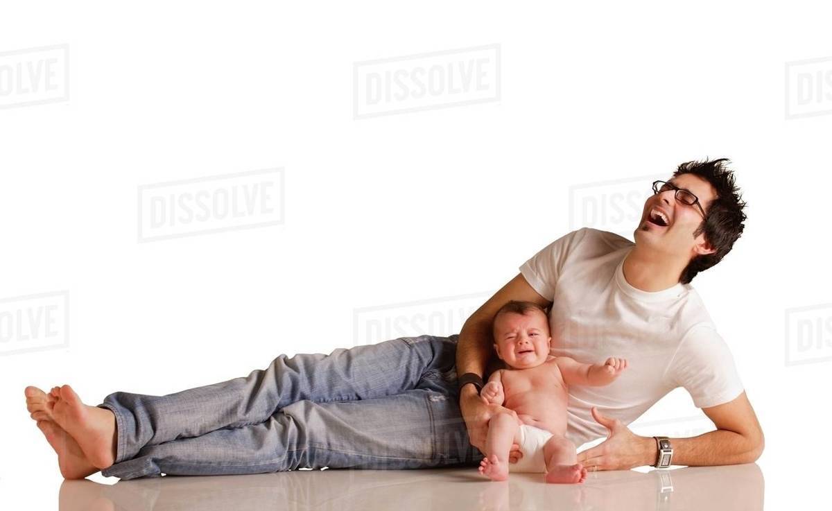 Laughing Dad With Baby - Stock Photo - Dissolve