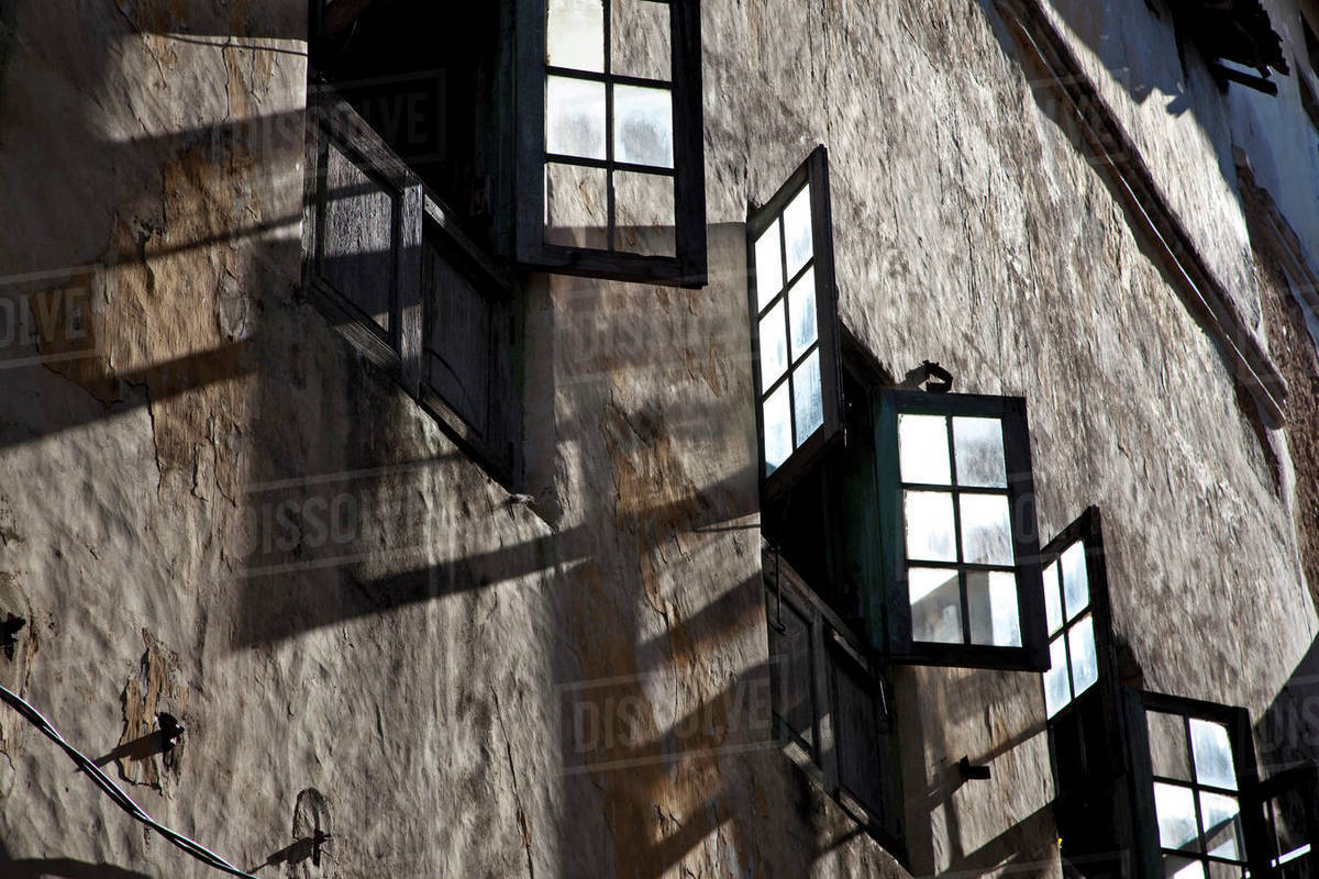 Open windows cast shadows on a building wall; Zanzibar - Stock Photo ...