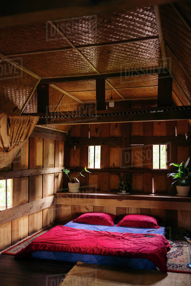 Interior of a traditional home called Tongkonan, with a mattress on the ...