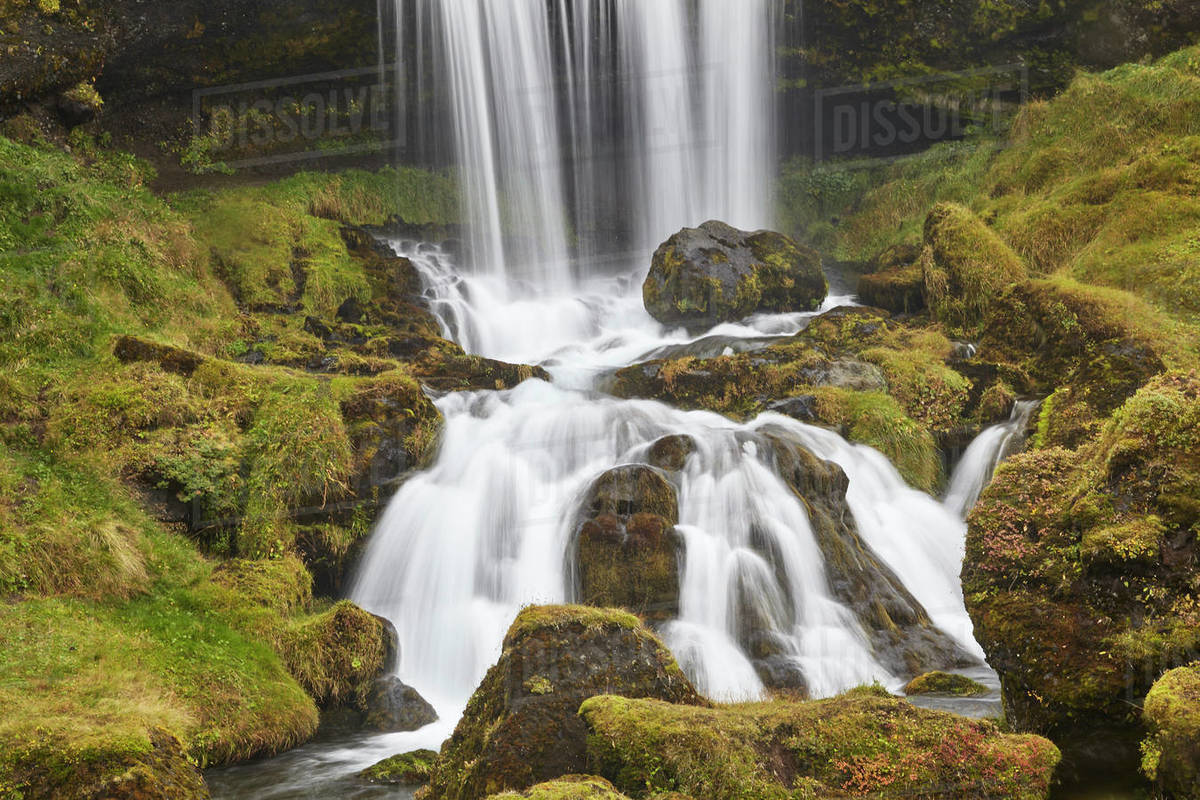 Cascades of the Hafrafell waterfall in mountains near Stykkisholmur ...