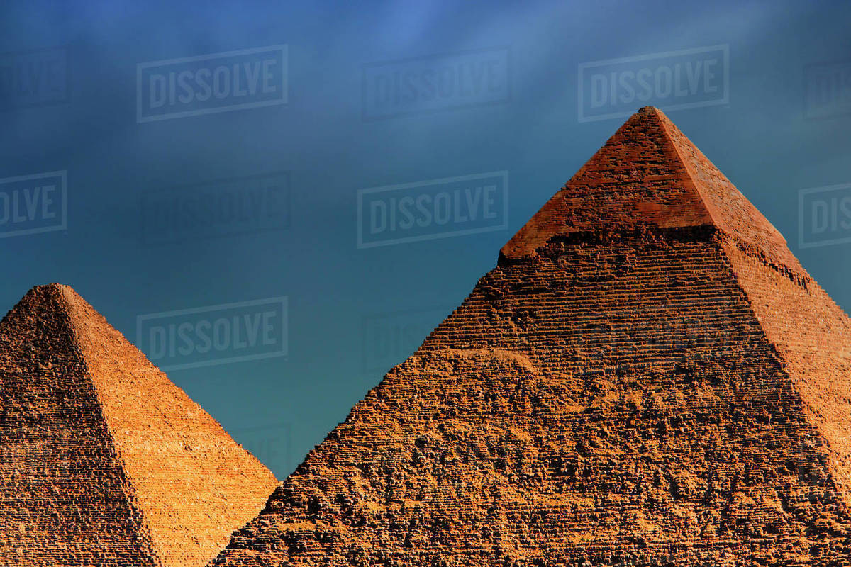 Two of the primary Pyramids of Giza, sunlit with a golden hue, the ...