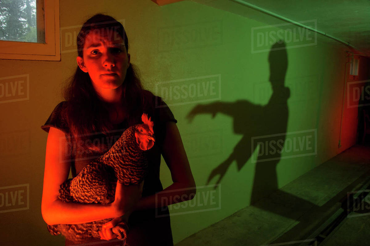 Staged horror scene with a young woman and a chicken; Lincoln, Nebraska ...