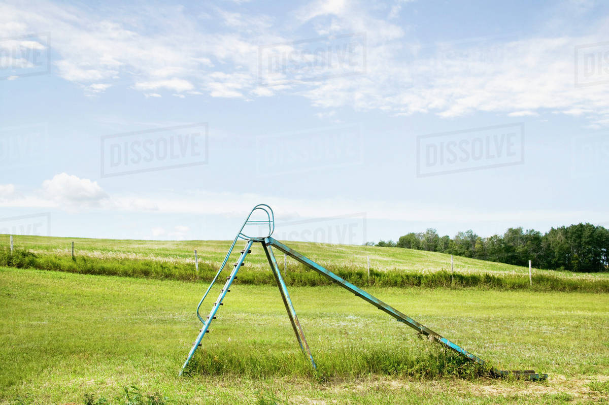An Old Metal Slide In A School Yard; Saskatchewan, Canada - Royalty ...