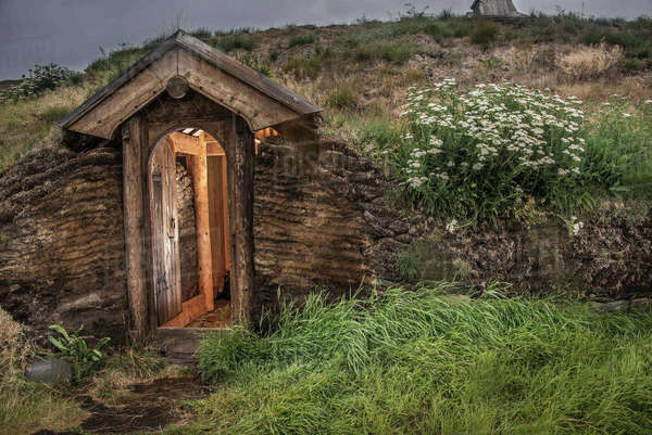 Stone and turf structure with wooden doorway at the recreated longhouse ...