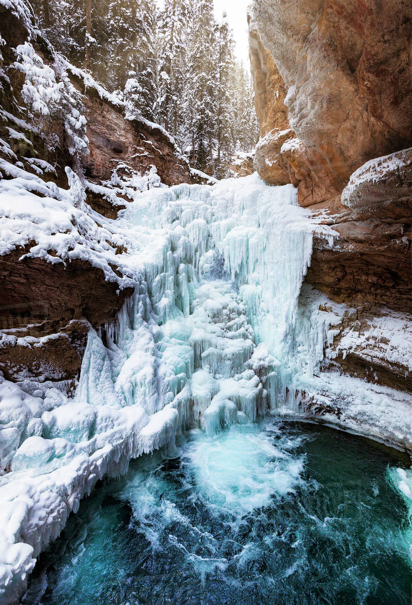 Frozen waterfall and pool at Johnston Canyon during winter in Banff ...