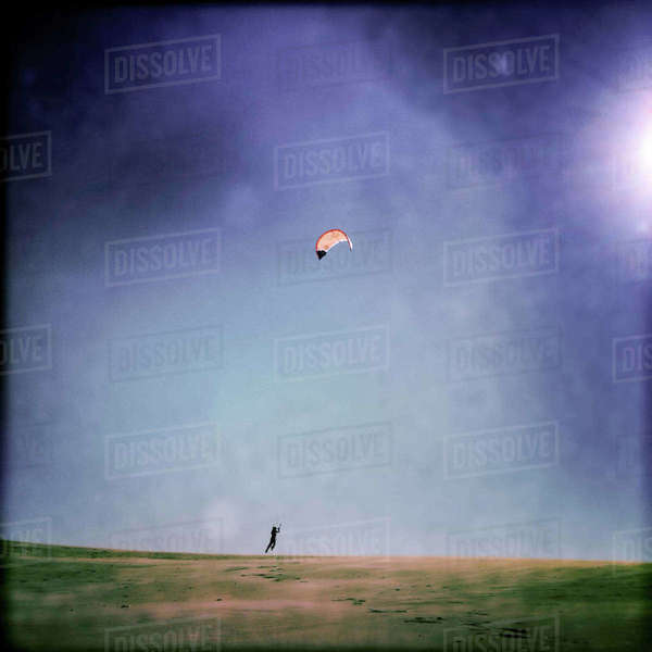 A 12 year old boy takes flight while sand kiting on the big dune at ...