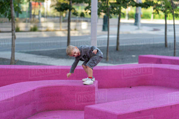 Young boy plays on a bright pink concrete structure in June Callwood ...