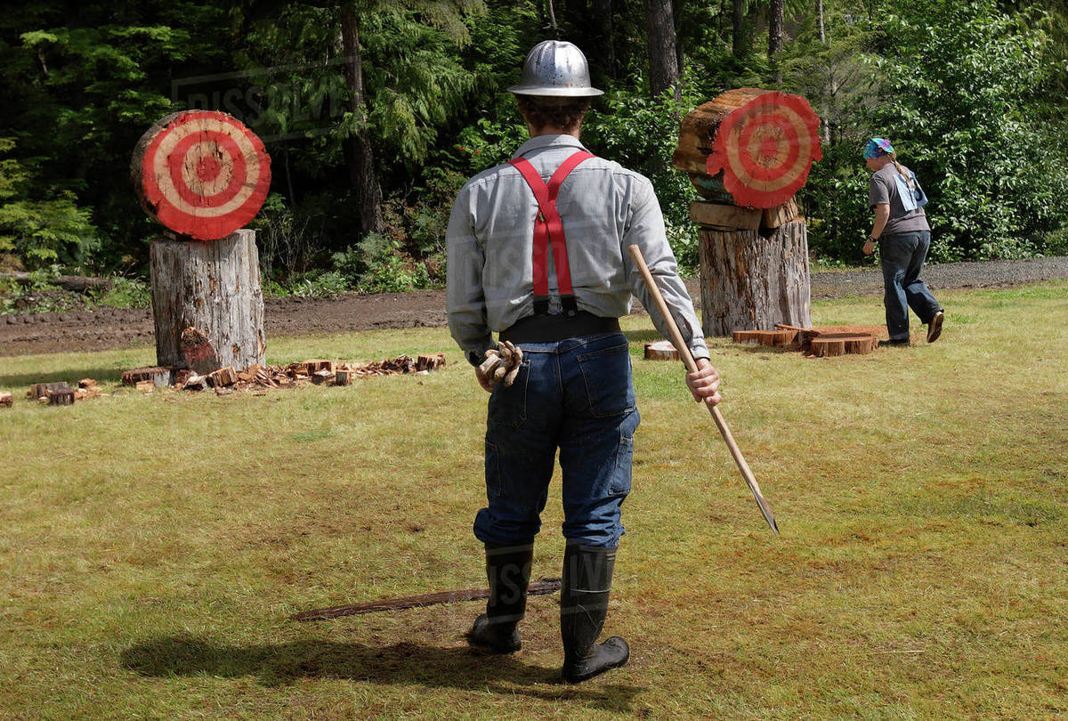 View taken from behind of lumbermen at the axe throwing contest at the ...