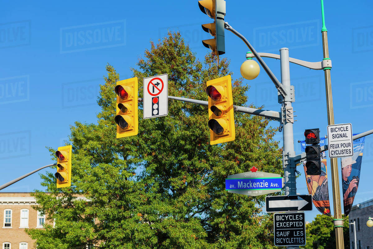 Traffic signs and traffic lights at an intersection; Ottawa, Ontario ...