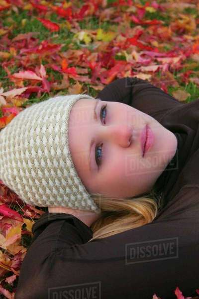 Young Woman Laying Back On Grass - Royalty-free Stock Photo | Dissolve