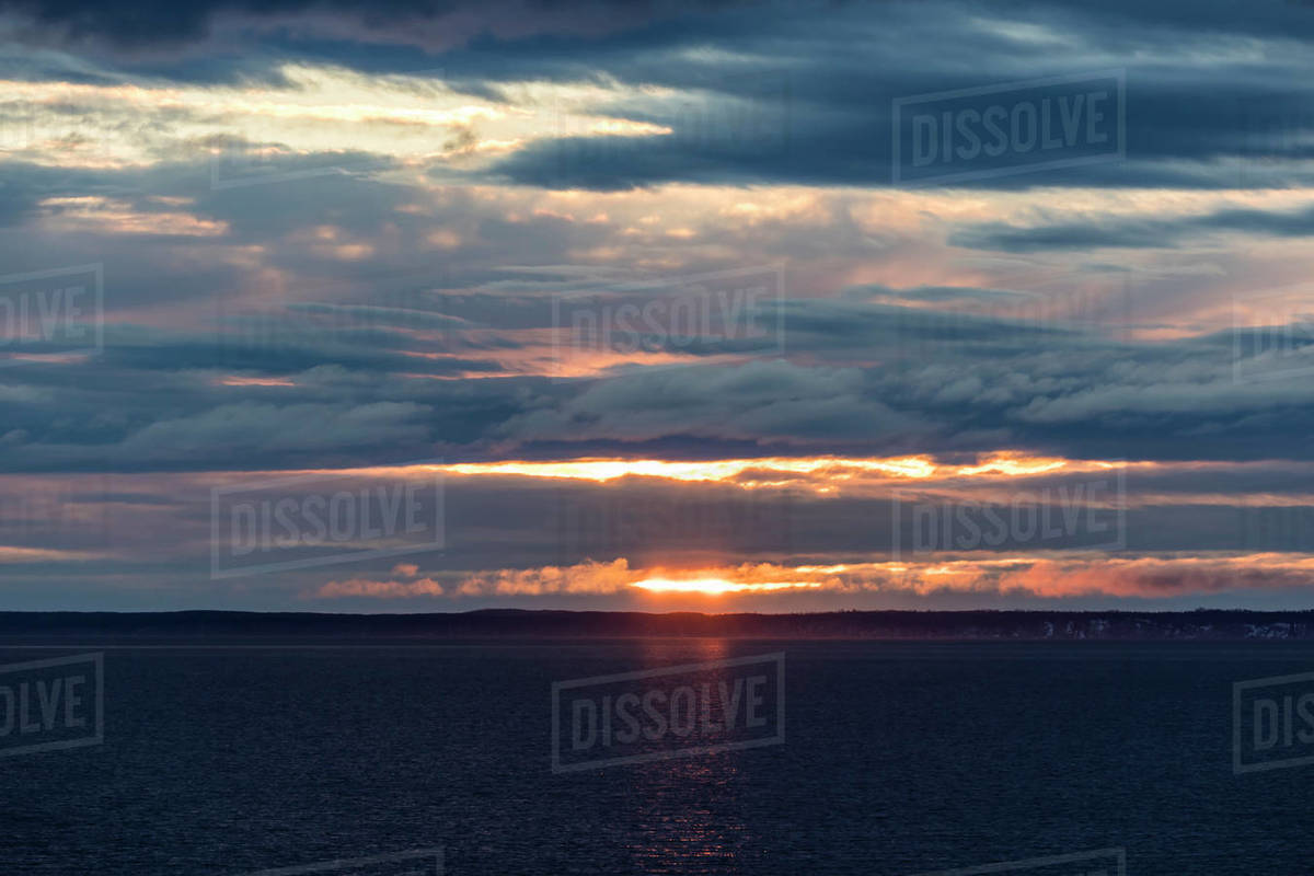 Dramatic clouds at the last light of sunset over the ocean at Turnagain ...