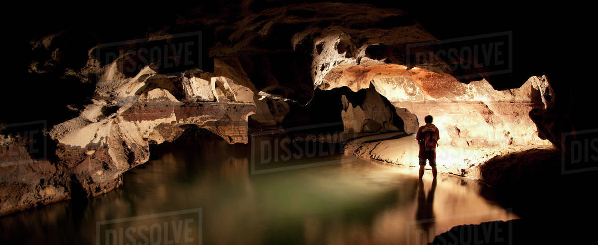 A Filipino Tour Guide Holds A Lantern Inside Sumaging Cave Or Big Cave ...