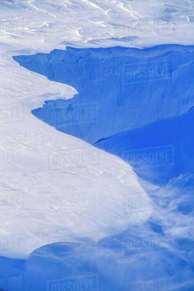 A cornice, an overhanging edge of snow formed by wind blowing snow over ...