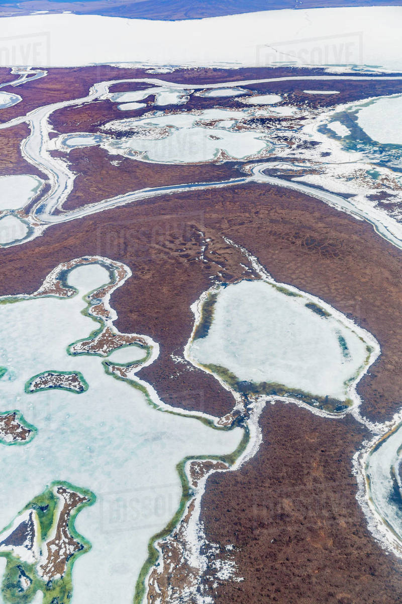 Aerial details of the tundra and melting ice on frozen ponds in Spring ...
