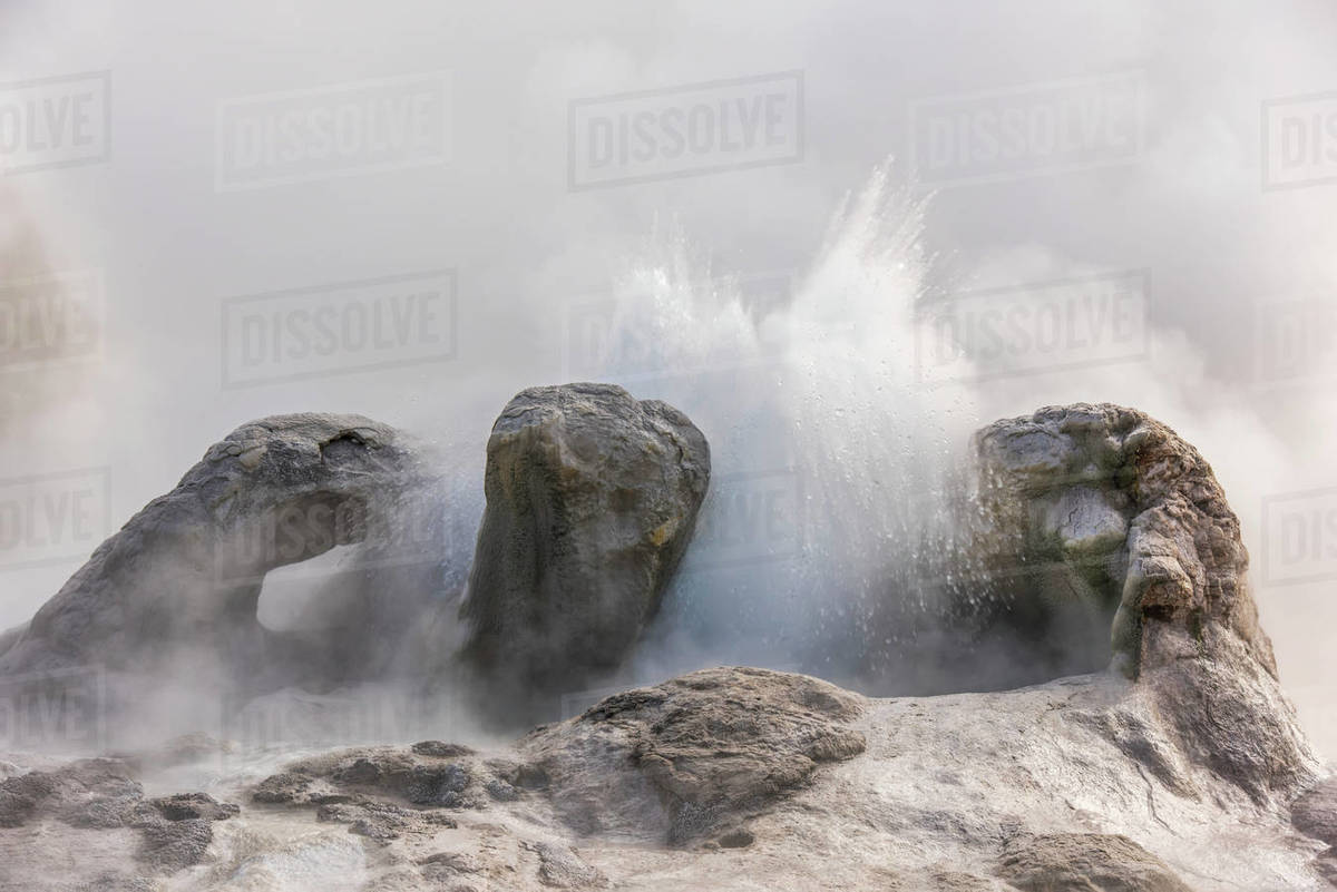 Steam and splashing water at the eruption of Grotto Geyser in Upper ...