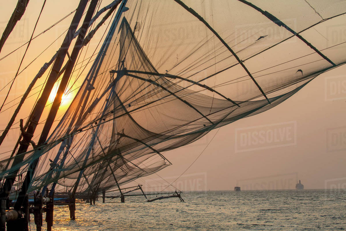 Traditional, 'Chinese' fishing nets at sunset in the mouth of the ...