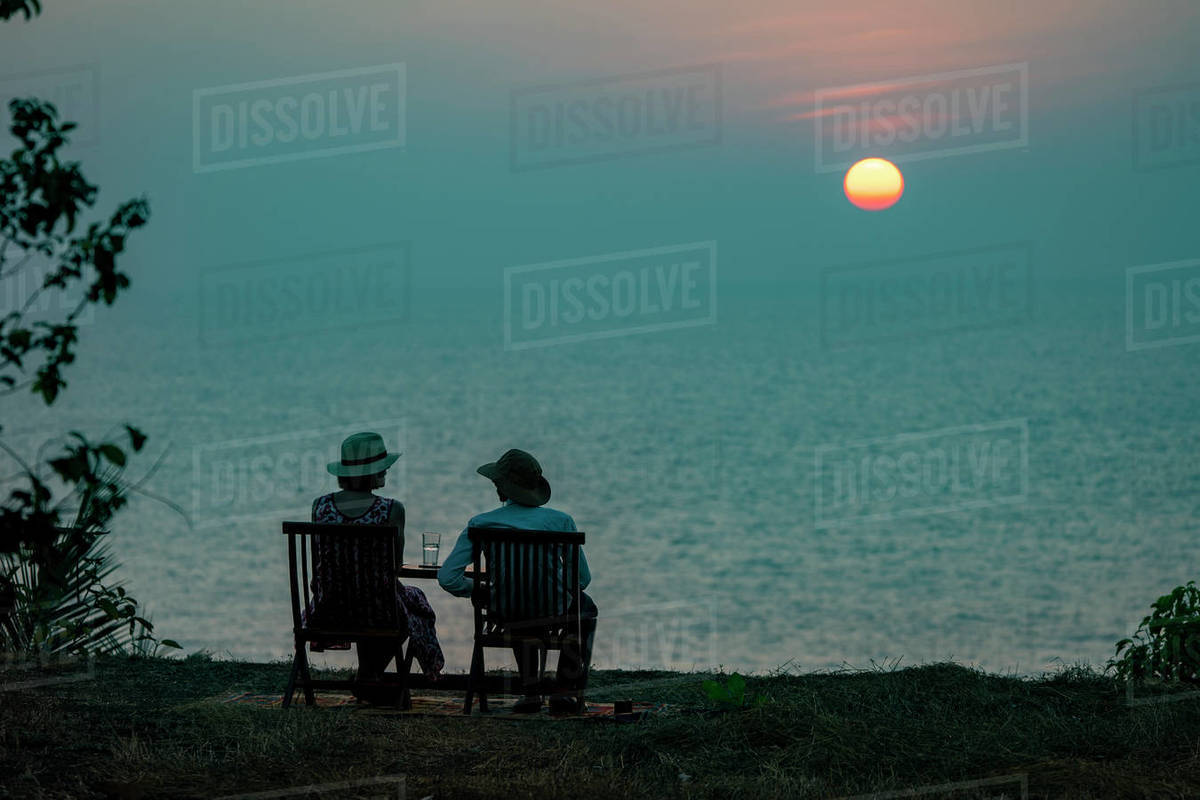 Guests enjoying sundowners (cocktails) on a cliff above Cabo Serai ...