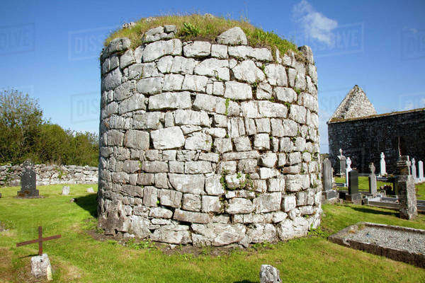 A Round Tower In A Cemetery; Killinaboy, County Clare, Ireland ...