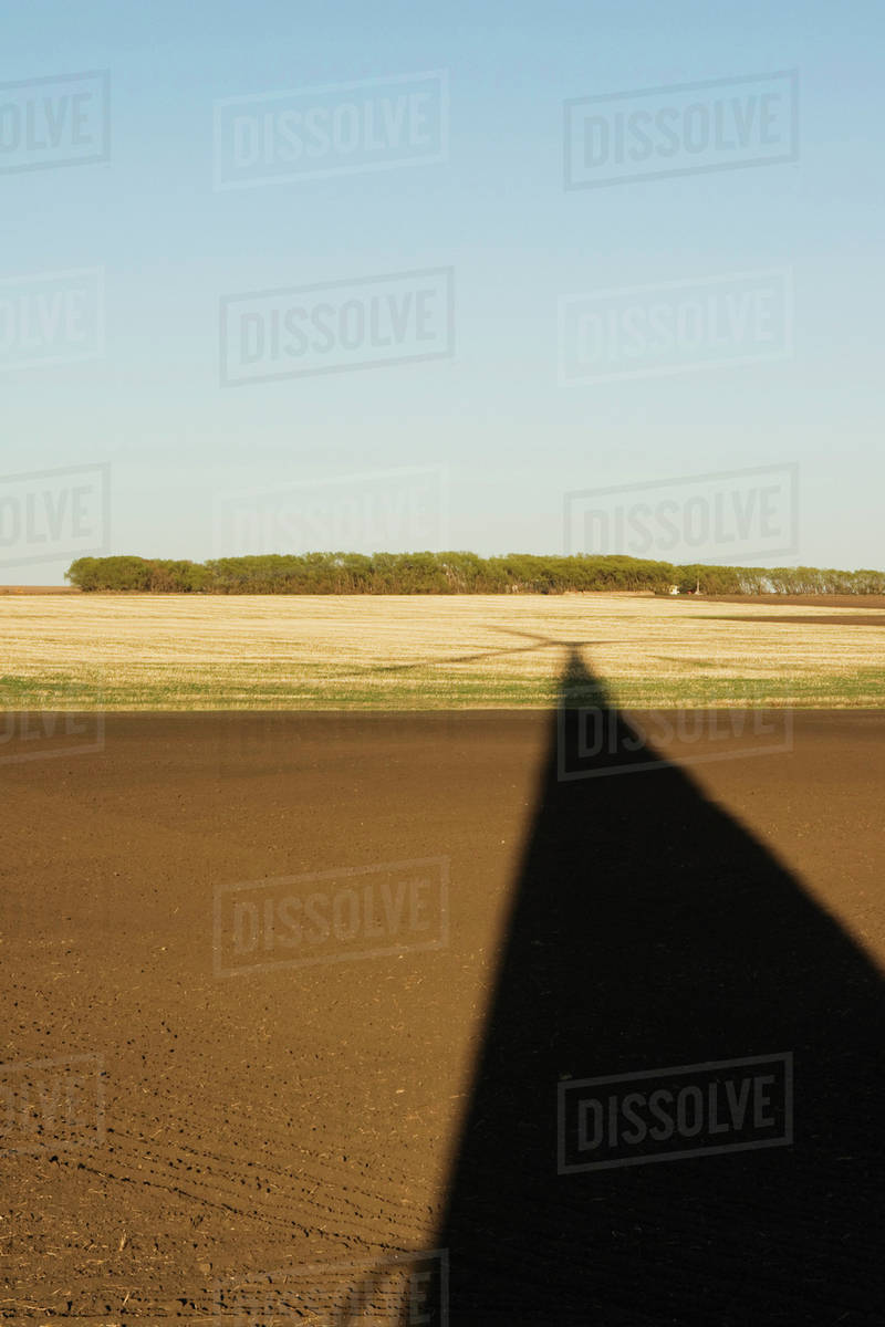 Long Shadow Of Wind Turbine On Ground - Stock Photo - Dissolve