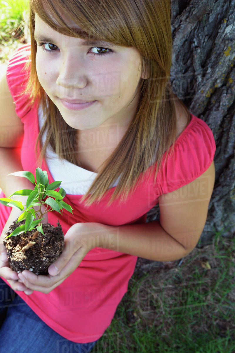 Thirteen Year Old Girl Seated Beside Tree Holding Small Tree, Winnipeg ...