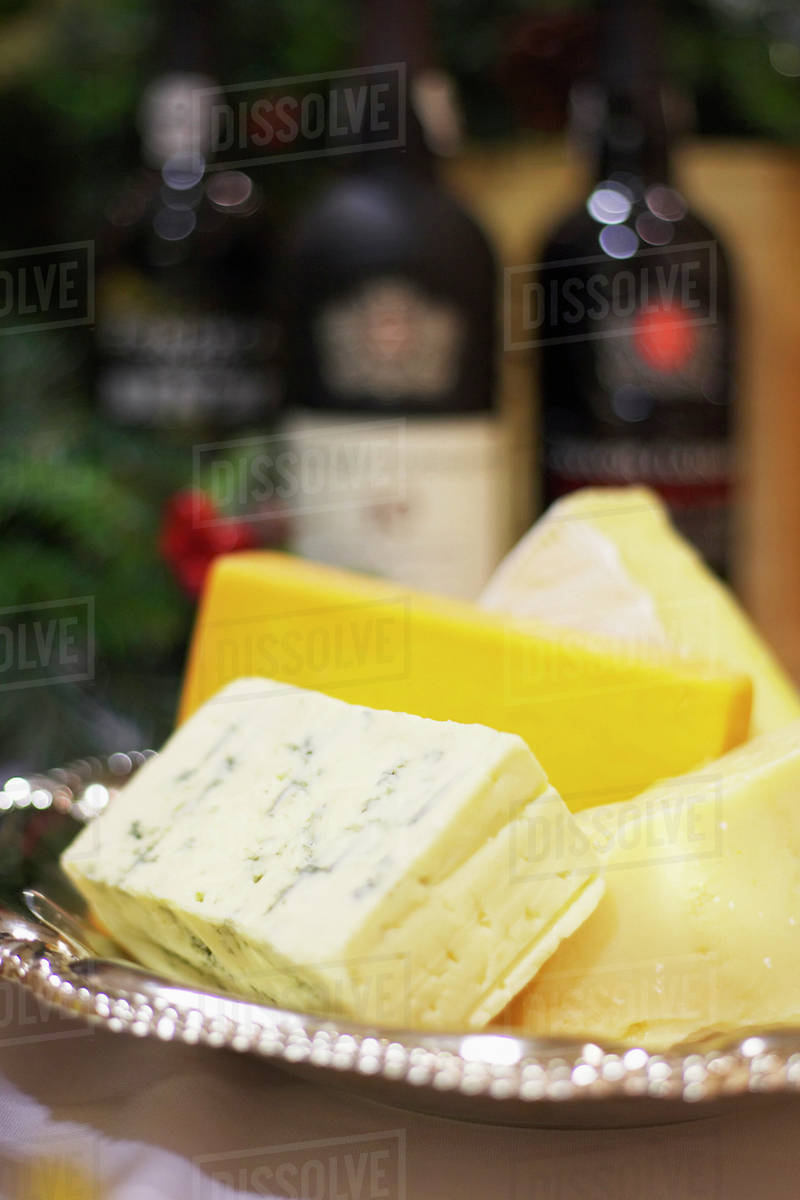 Bricks Of Blue, Cheddar, Parmesan, And Brie Cheese In A Silver Dish ...