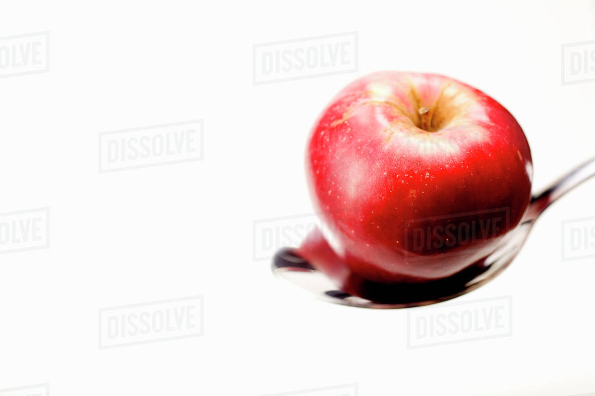 Organic Apple In Spoon - Royalty-free Stock Photo | Dissolve