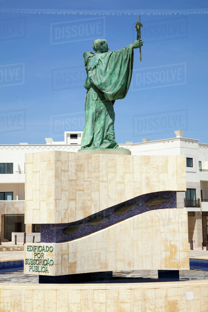 Green Statue Of A Male Figure Holding A Cross; Lagos Algarve, Portugal ...