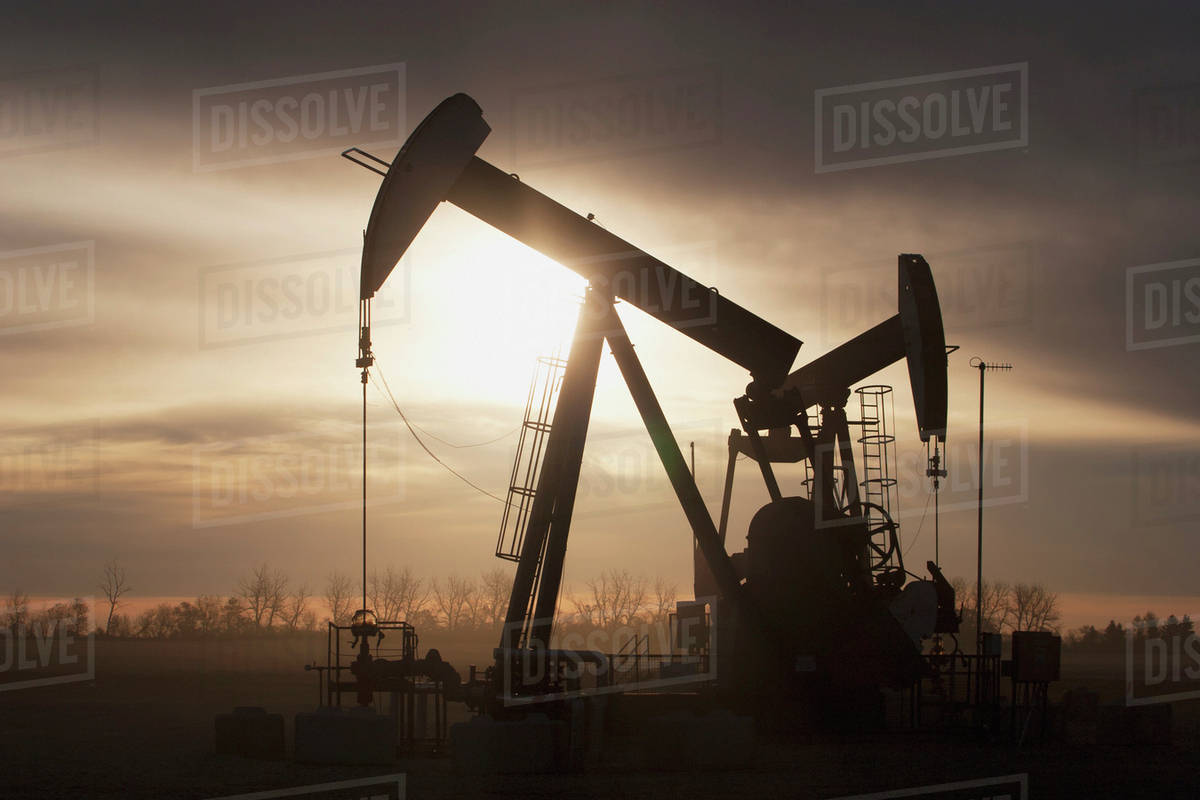 Silhouette Of Two Pump Jacks At Sunrise With Clouds; Alberta, Canada ...