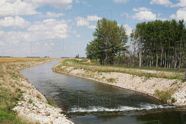 Irrigation canal with small rapids blue sky and clouds east of high ...