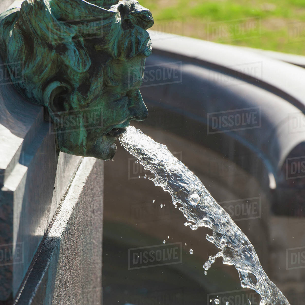 A gargoyle in human likeness spraying water;Zurich switzerland ...