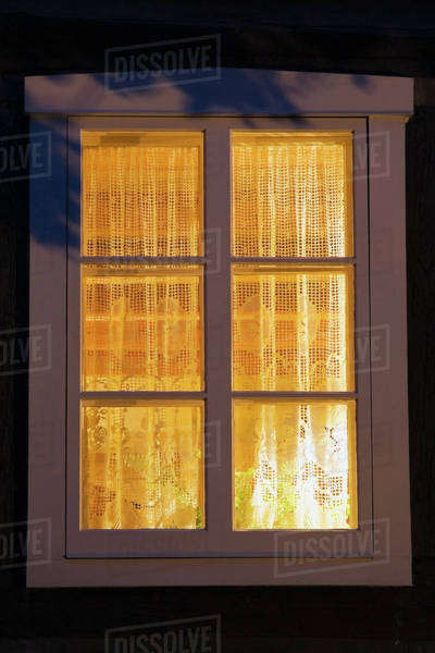 Lit window on the side of an old log home at dusk;Quebec canada - Stock ...