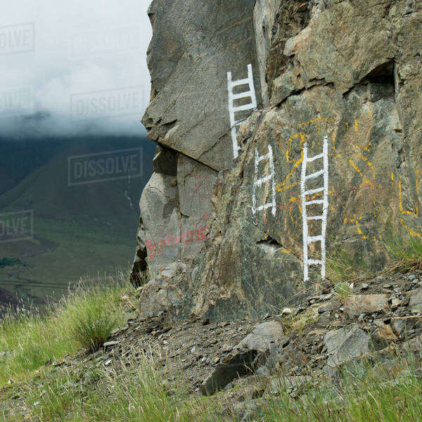 White ladders painted on the side of a steep rock cliff;Xizang china ...