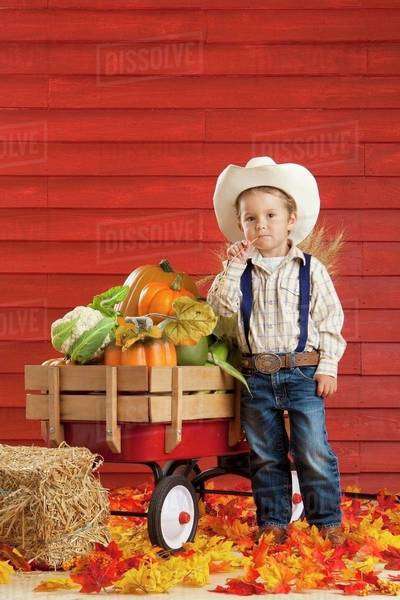A Boy Dressed As A Farmer With A Wagon Full Of Produce; Three Hills ...